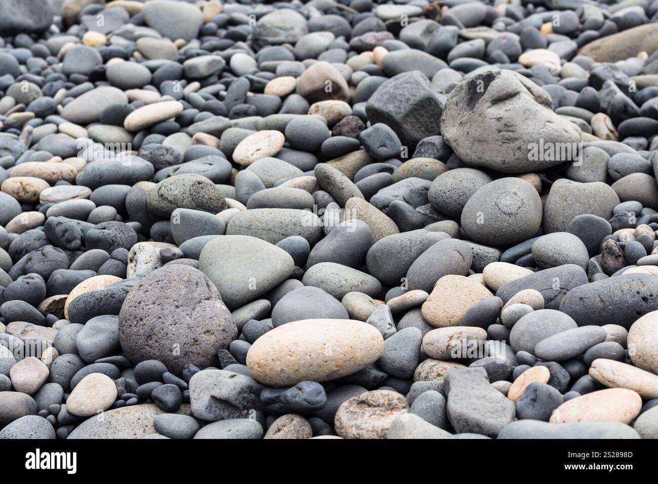travel to Iceland - cobbles on surface on Reynisfjara beach in Vik I ...