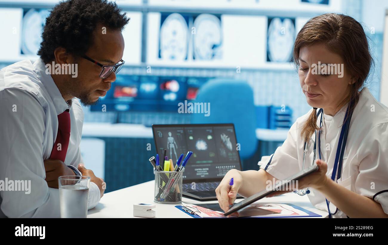 Medical expert discusses test results with a patient in a healthcare ...
