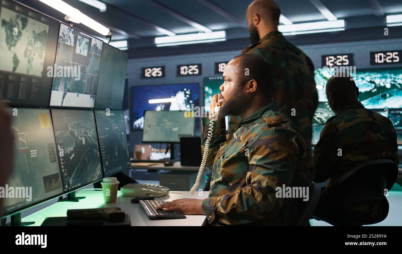 Military officer making telephone call to relay enemy info gained using tracking equipment. Army ...