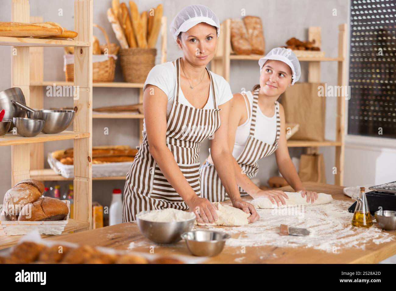 Two bakers knead dough Stock Photo - Alamy