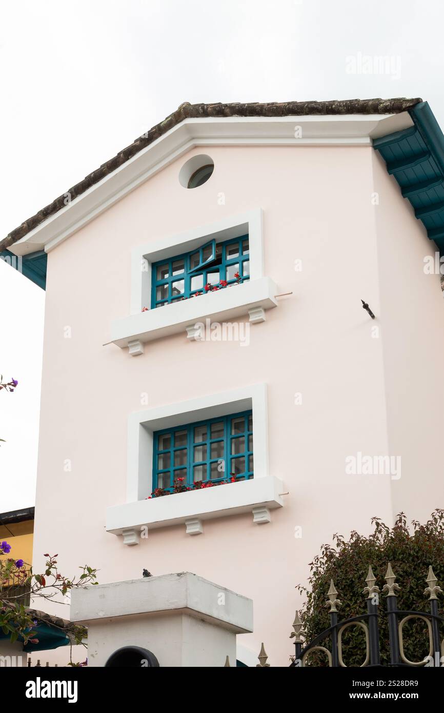 A two-story house with a rectangular roof and small windows. The simple ...