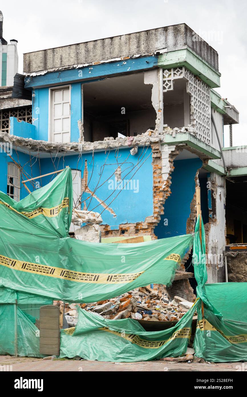 A building damaged by an earthquake, with visible cracks and debris ...