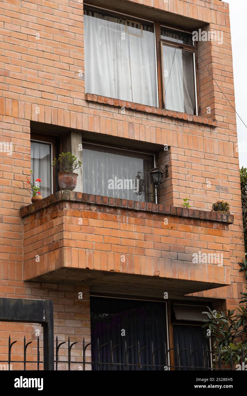 A brick building with a charming balcony, showcasing a classic ...