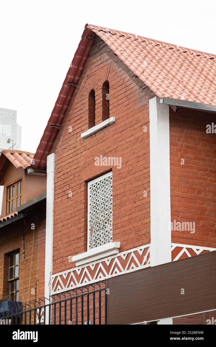 A brick house with a triangular roof and small windows, exuding a cozy ...