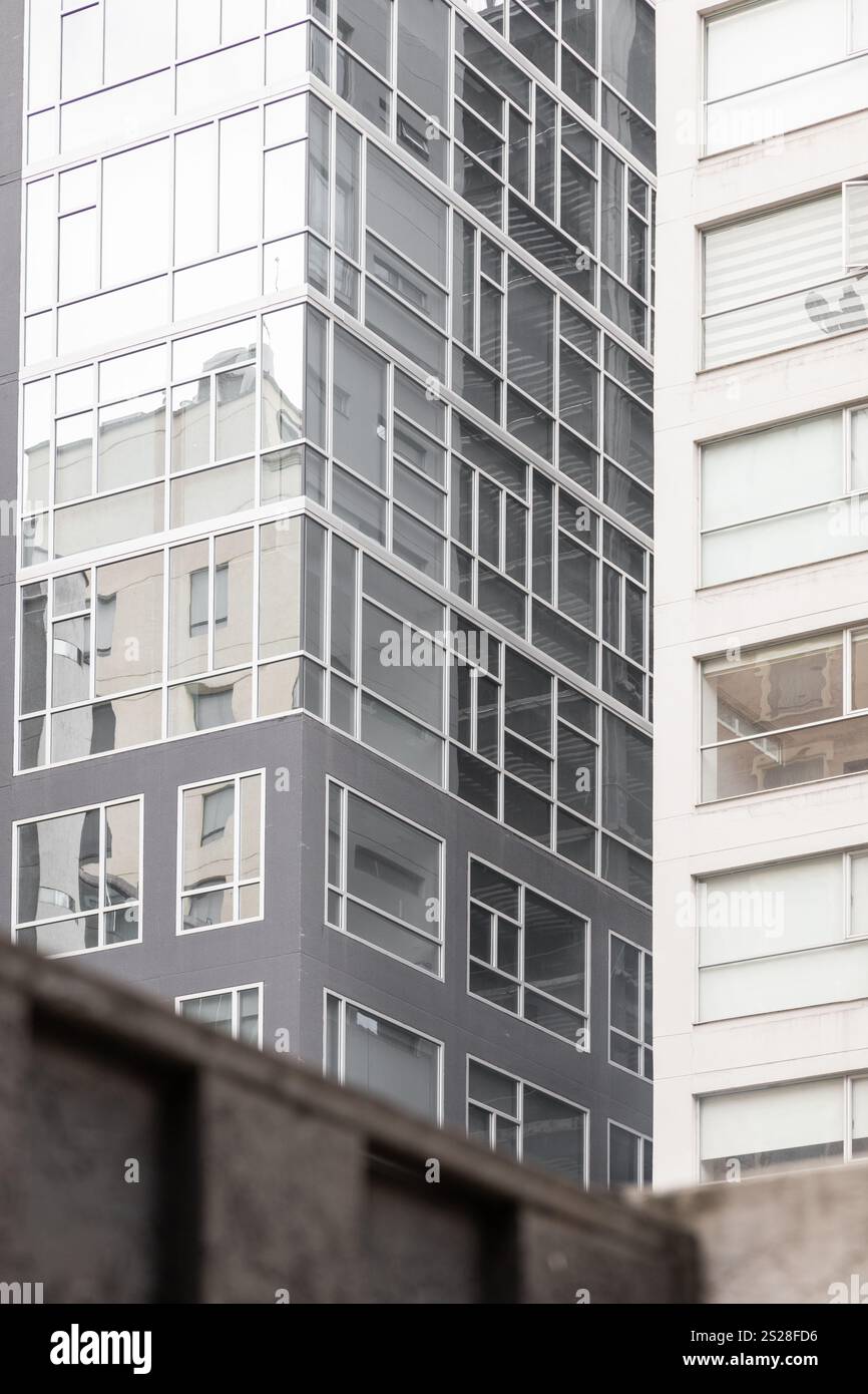 A tall glass building with square windows, creating a sleek and modern ...