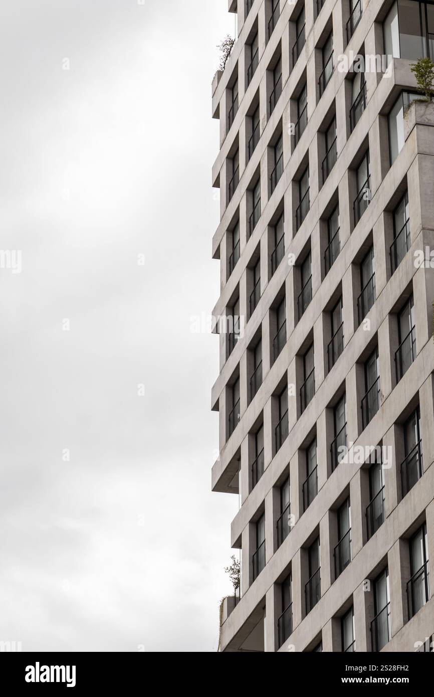 A brick building with square windows, showcasing a classic ...