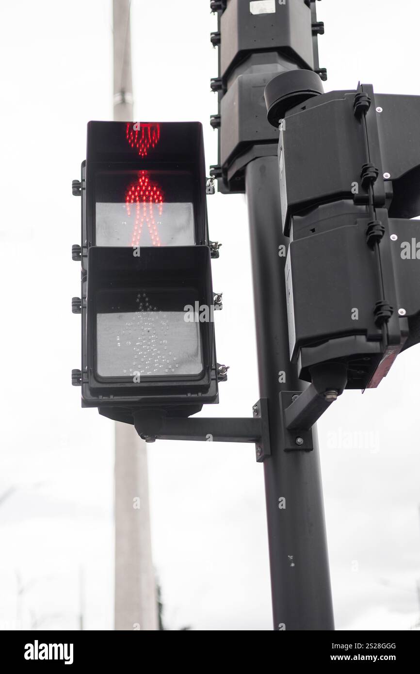 A pedestrian traffic light showing red. The bright red light signals ...