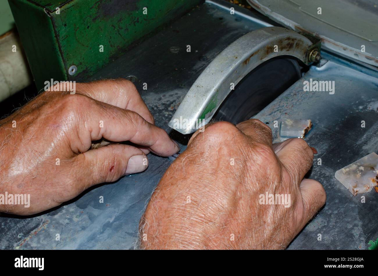 Lapidary rock, stone, gem cutting, shaping and polishing. Man in ...