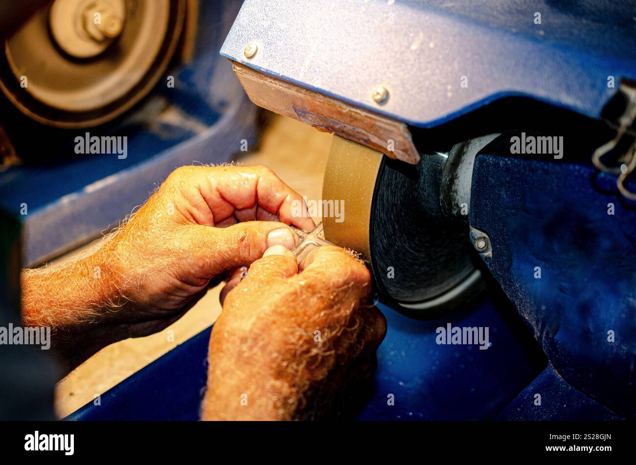Lapidary rock, stone, gem cutting, shaping and polishing. Man in ...