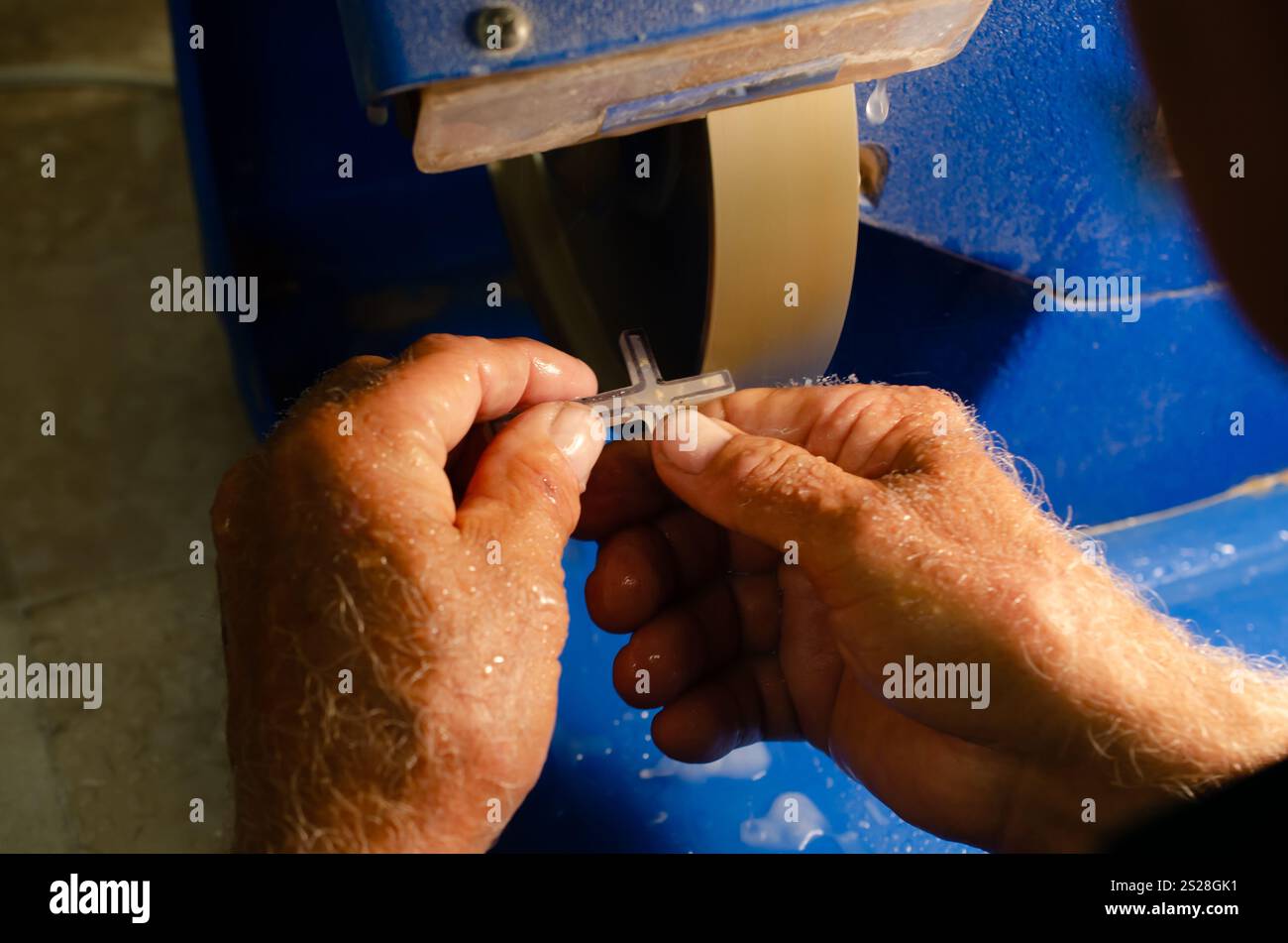 Lapidary rock, stone, gem cutting, shaping and polishing. Man in ...