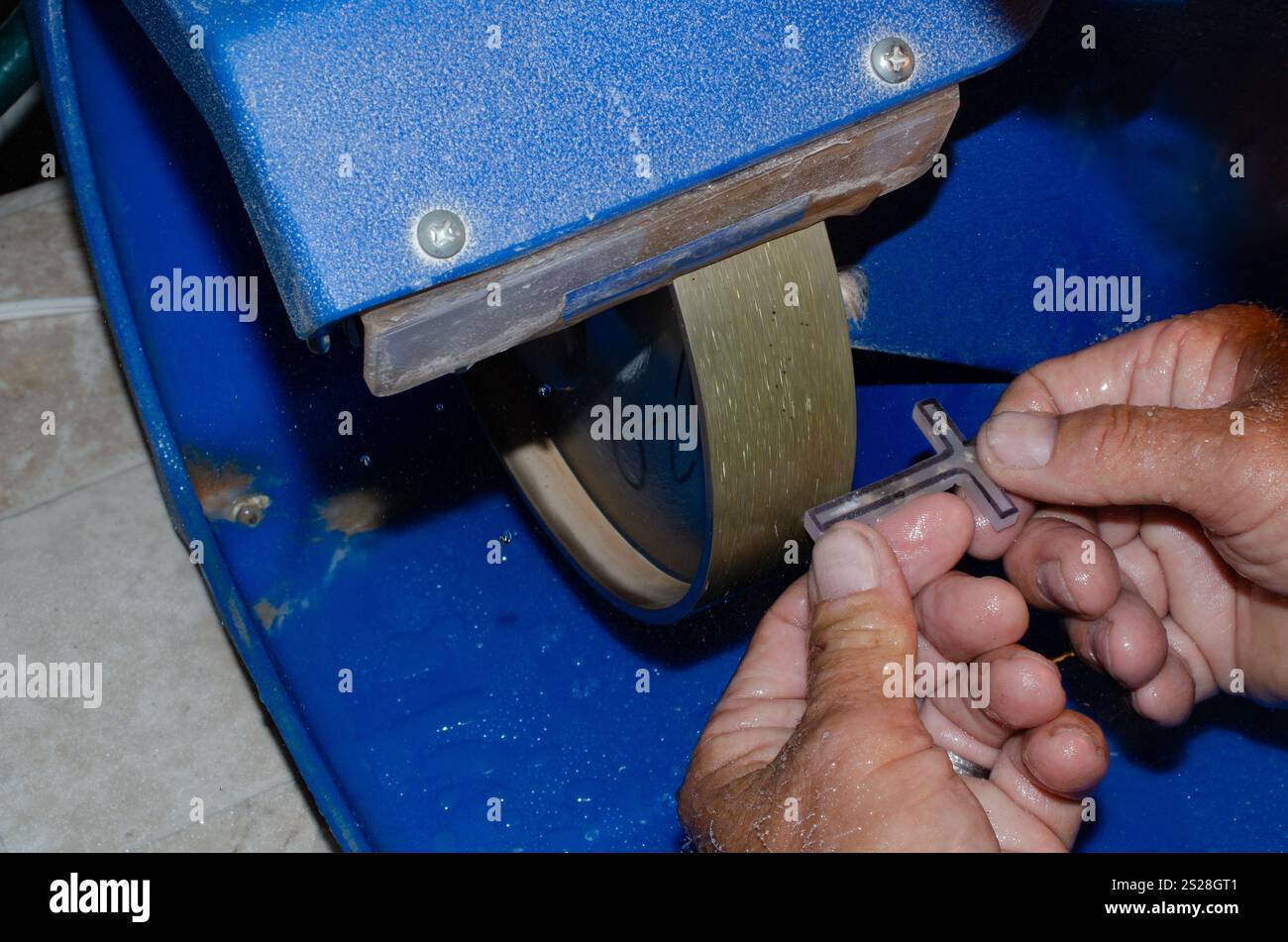 Lapidary rock, stone, gem cutting, shaping and polishing. Man in ...