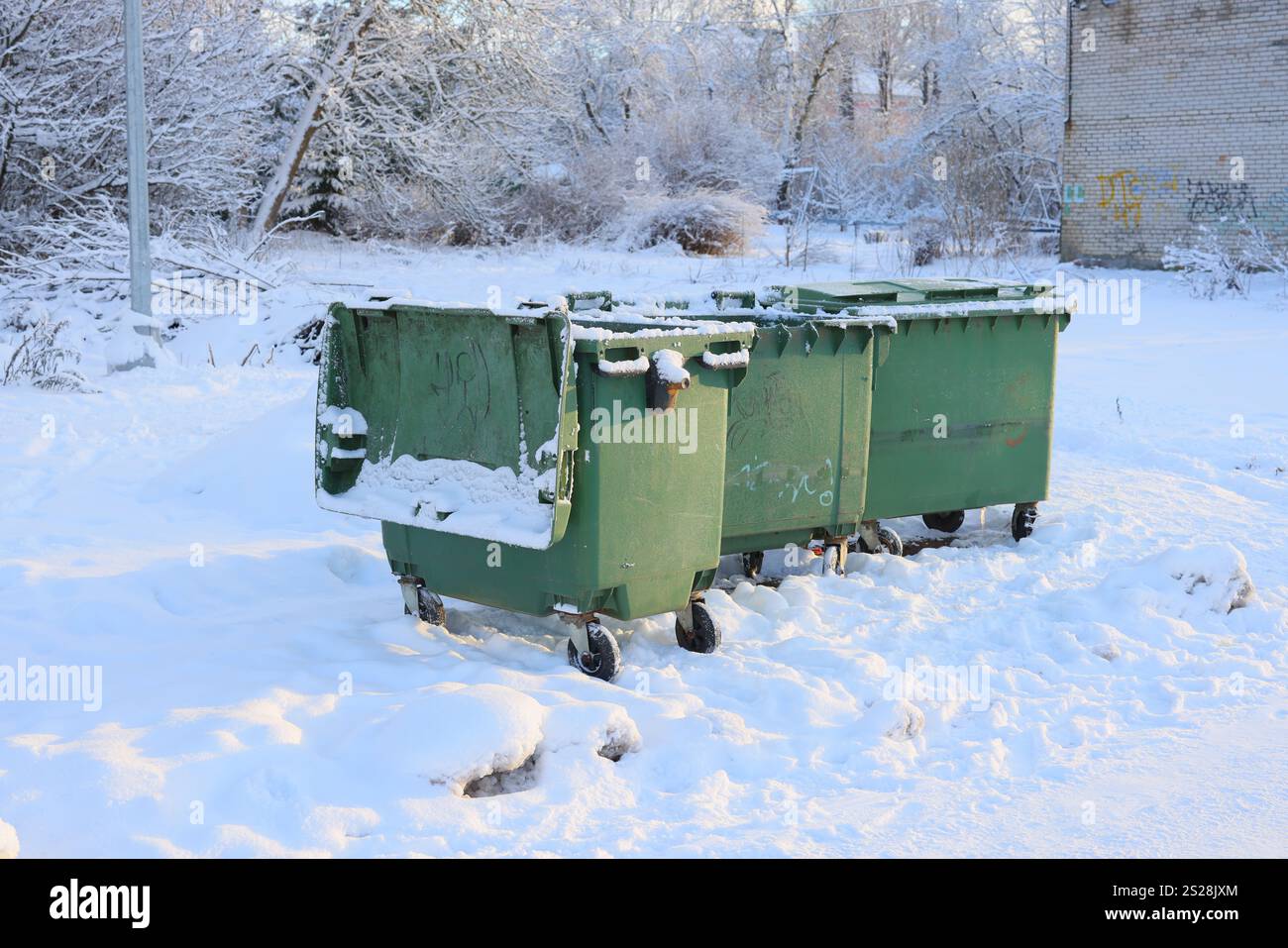 A beautiful winter scene featuring snowcovered trash bins that are ...