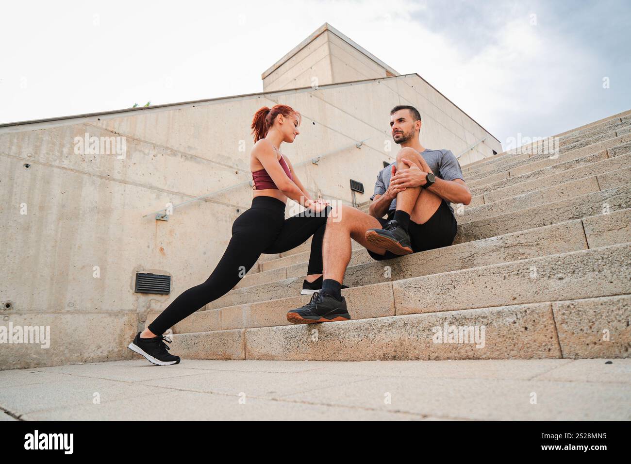 Fitness enthusiasts engaged in a stretching routine. Sporty young ...