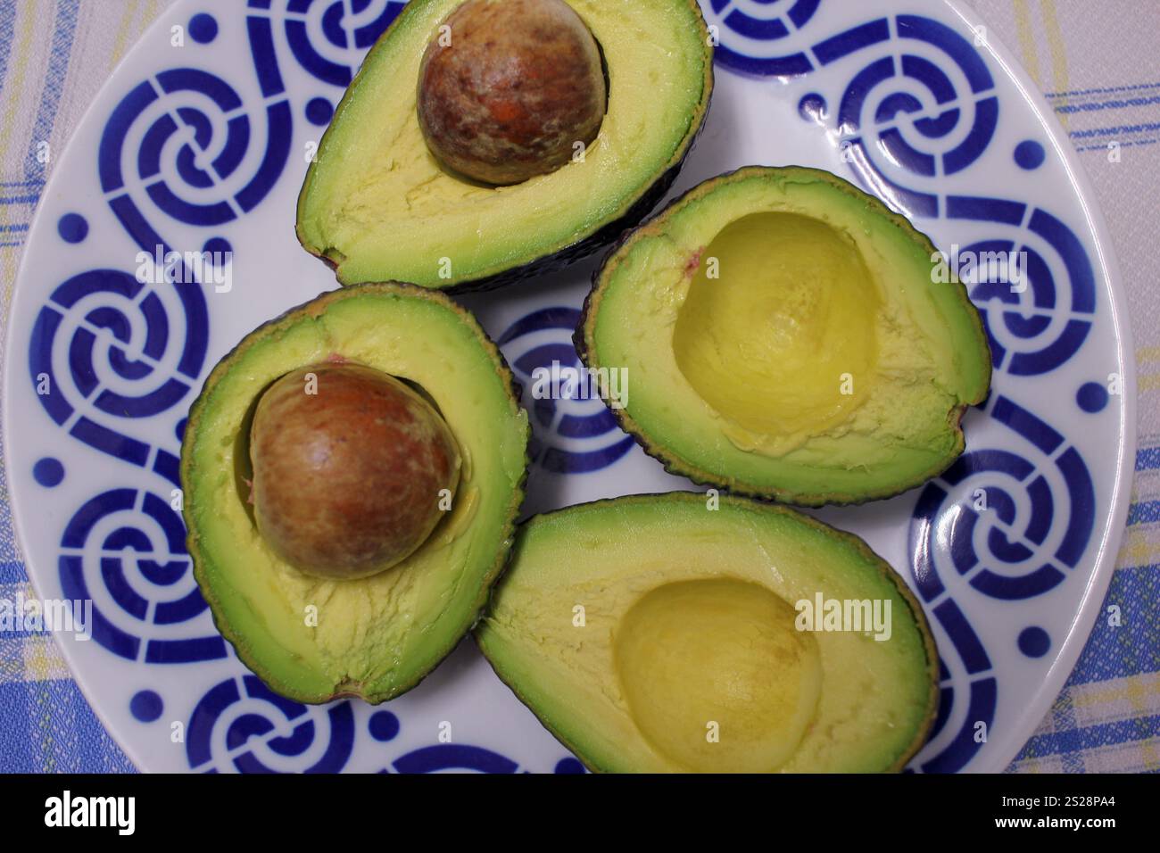 two avocados in a dish are a healthy eating Stock Photo - Alamy