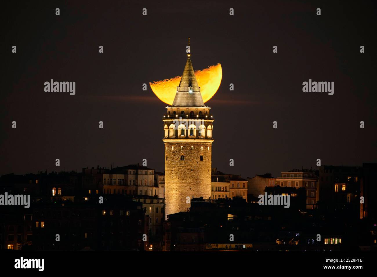 A half moon sets behind the Galata Tower in Istanbul, Tuesday, Jan. 7 ...