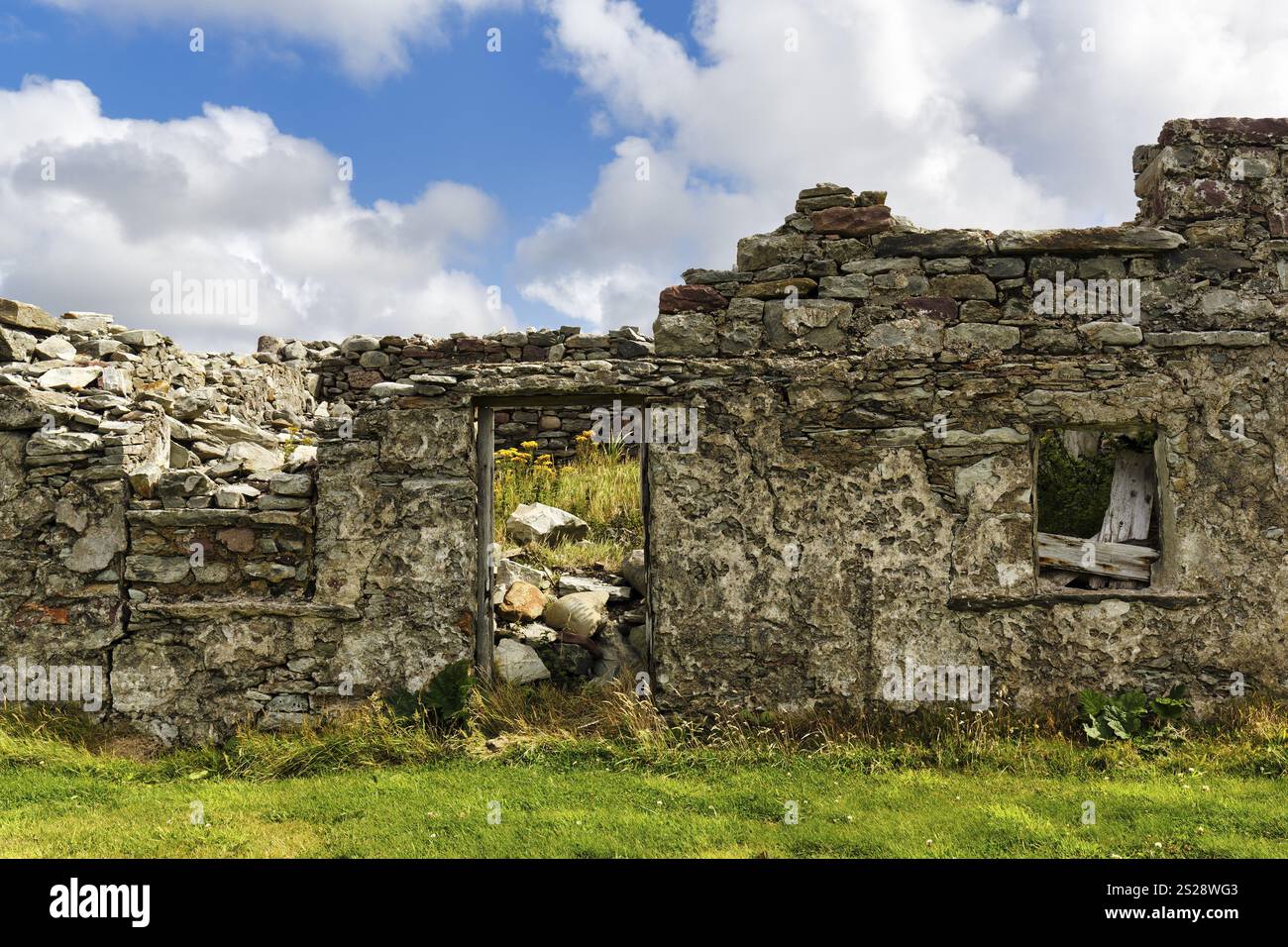 Facade of a ruin, dilapidated stone house, overgrown, symbolic photo ...