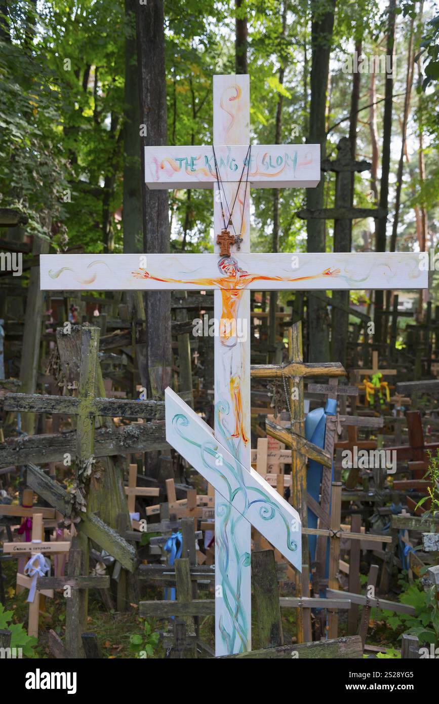 Colourfully painted wooden cross with artistic design, surrounded by ...