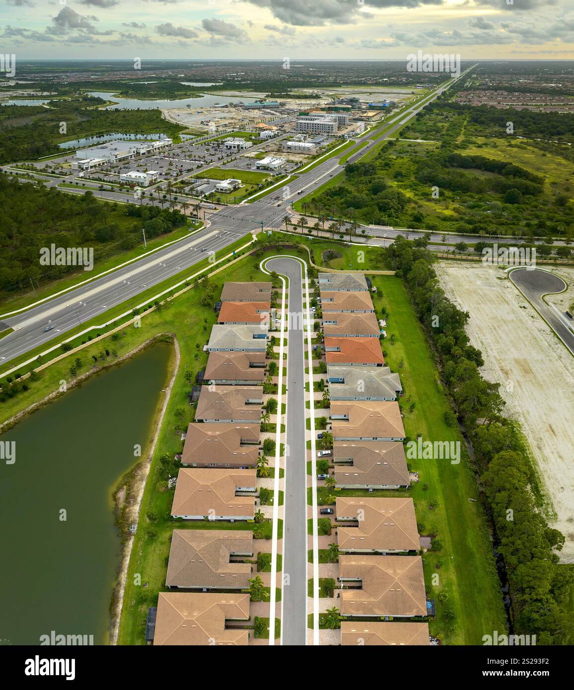 Aerial view of tightly located family houses with retention ponds to ...