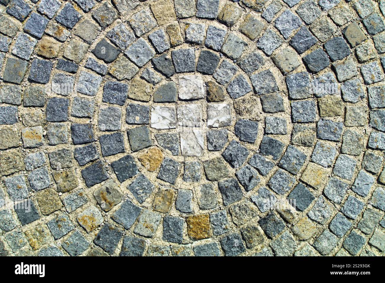 Granite paving stones were laid in circles on a square. A cross in the ...
