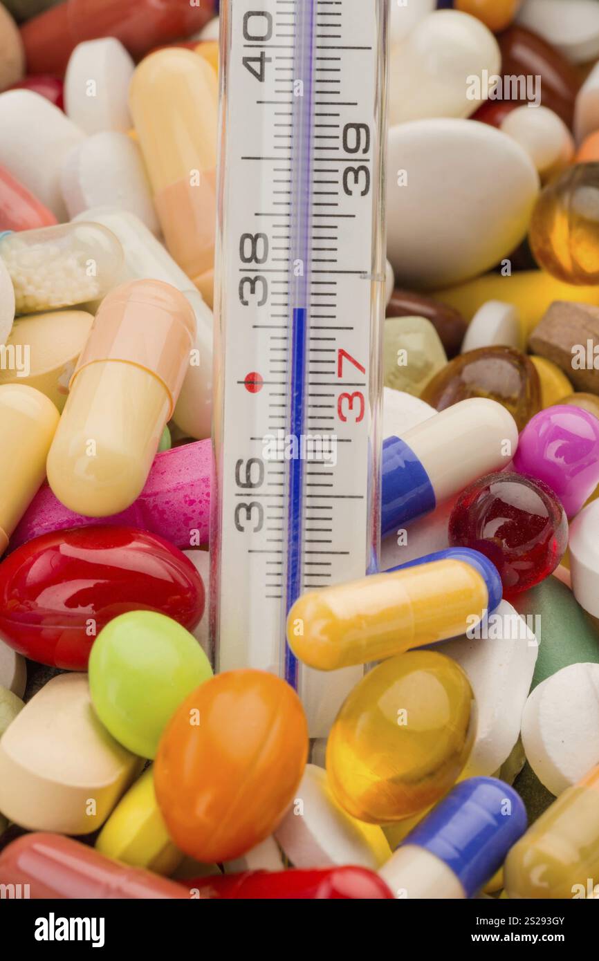 Clinical thermometer and tablets, symbolic photo for illness and medication Austria Stock Photo ...