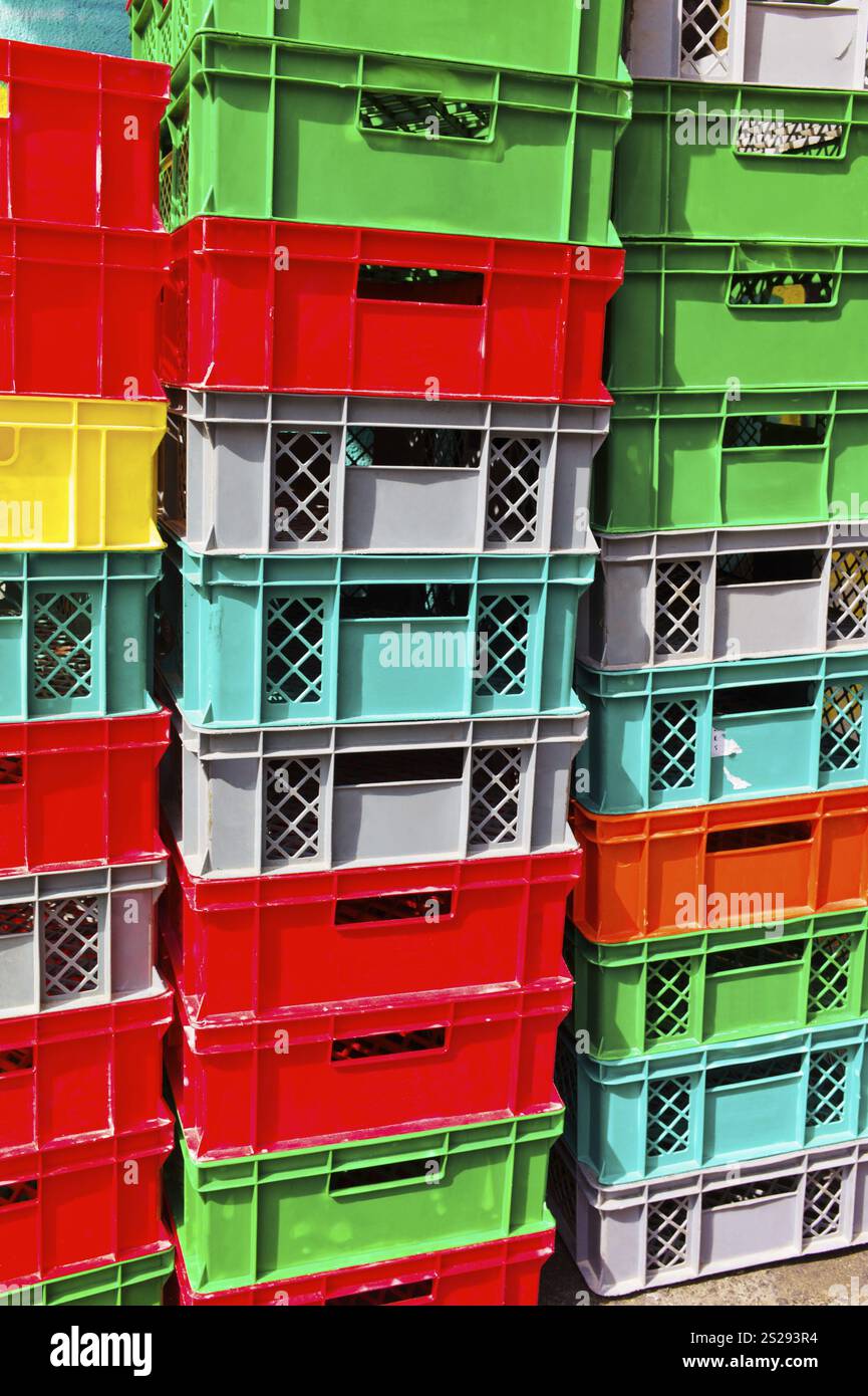 Colourful plastic crates are waiting to be transported away. Logistics ...