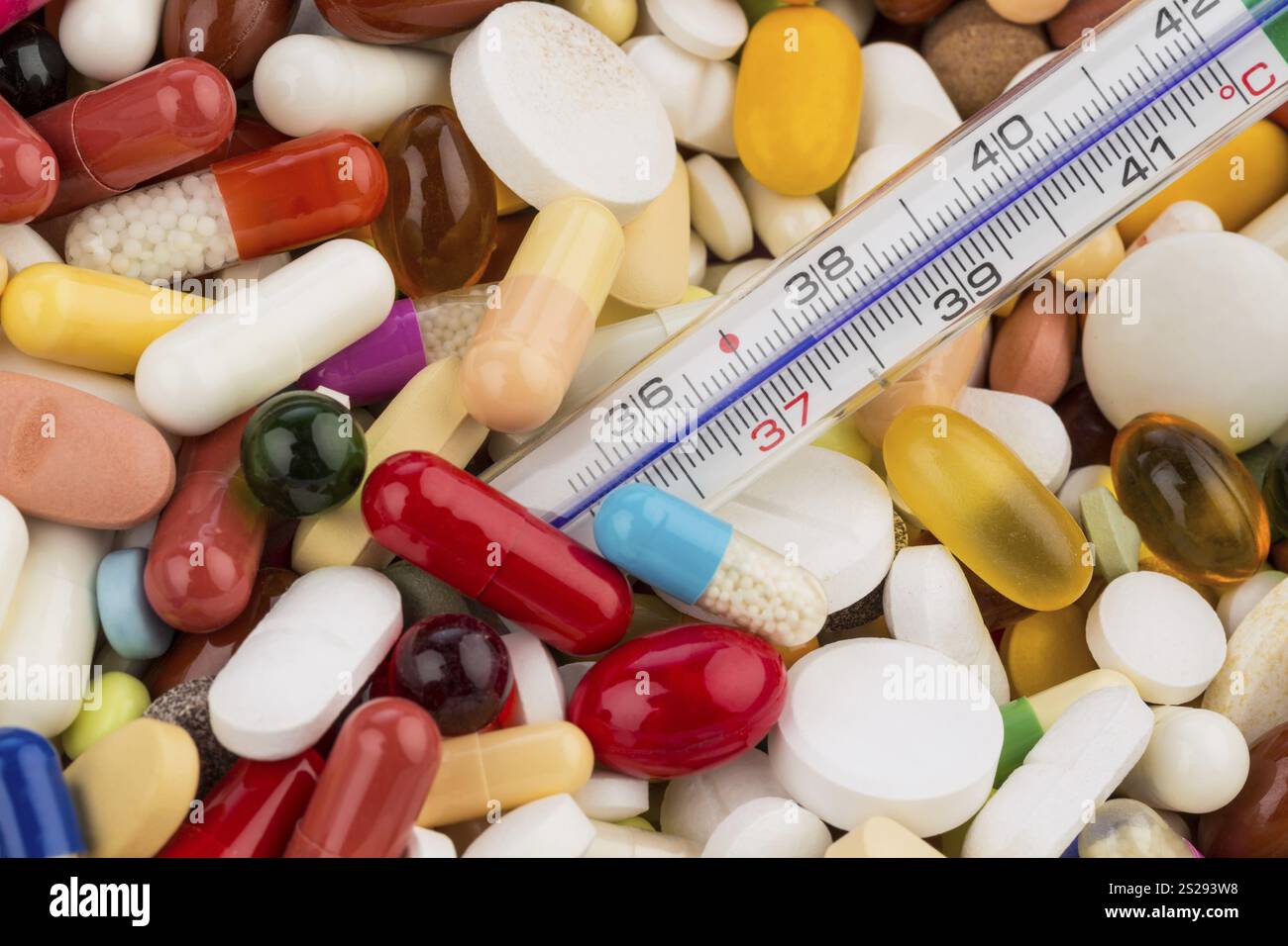 Clinical thermometer and tablets, symbolic photo for illness and ...