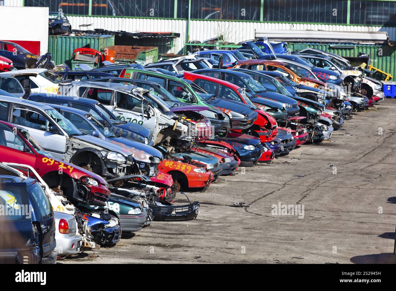 Old cars are stacked in a scrapyard. Scrap cars in a car graveyard ...