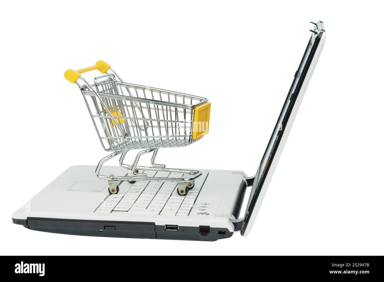 An empty shopping trolley on a laptop computer. Symbol photo for ...