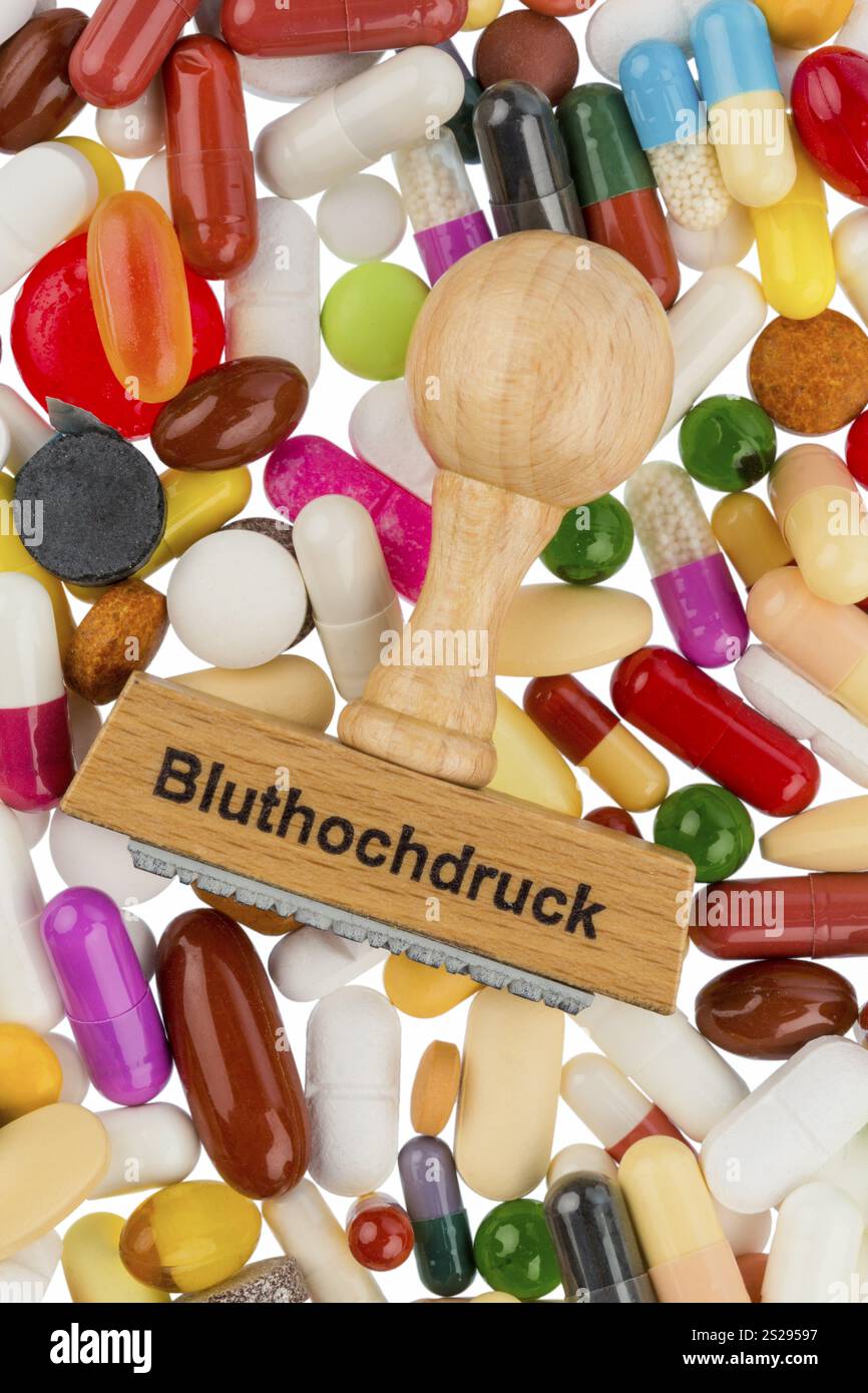 Stamp on colourful tablets, symbolic photo for high blood pressure ...