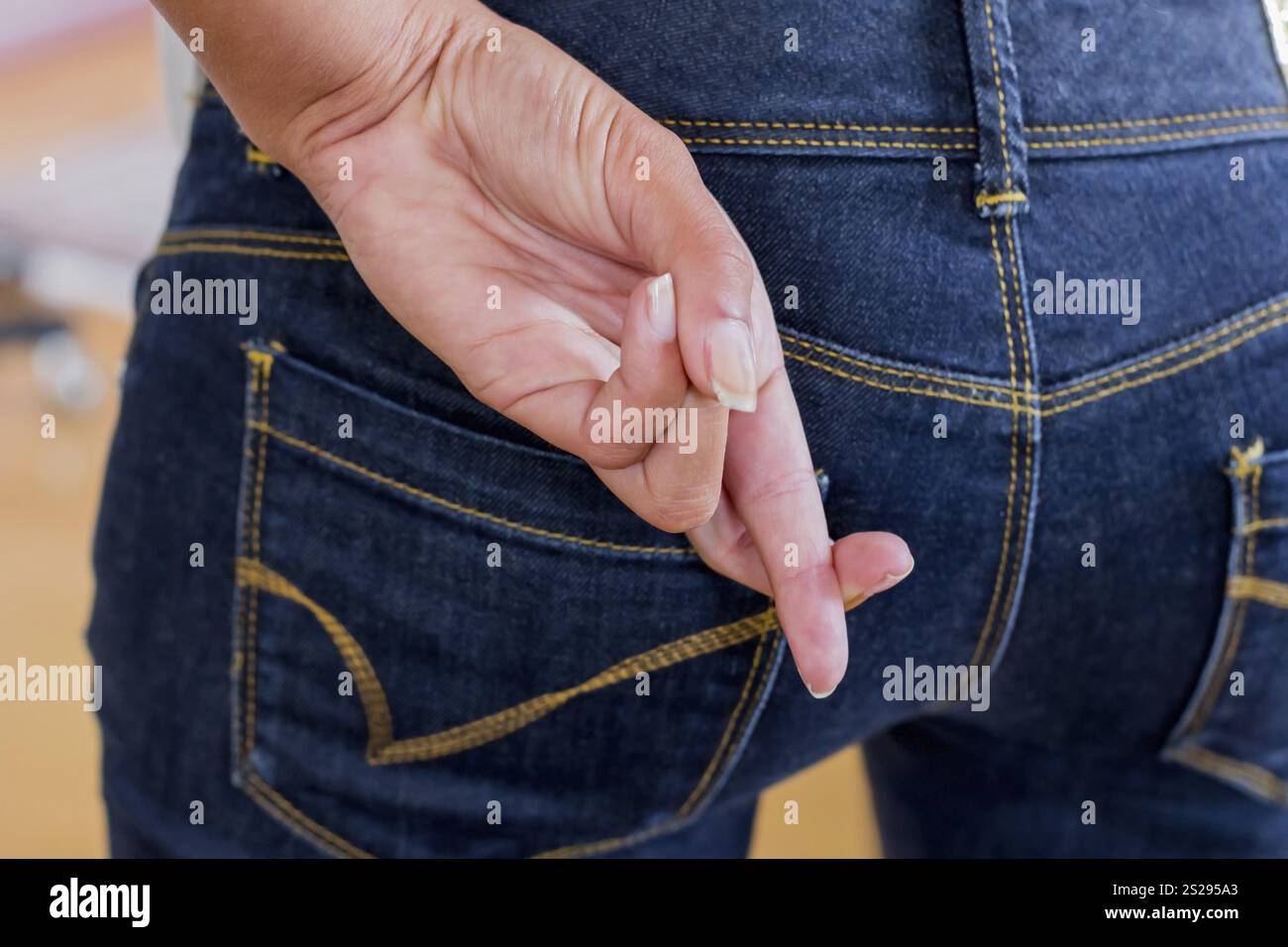 A woman holds her fingers crossed behind her back. She swears perjury ...