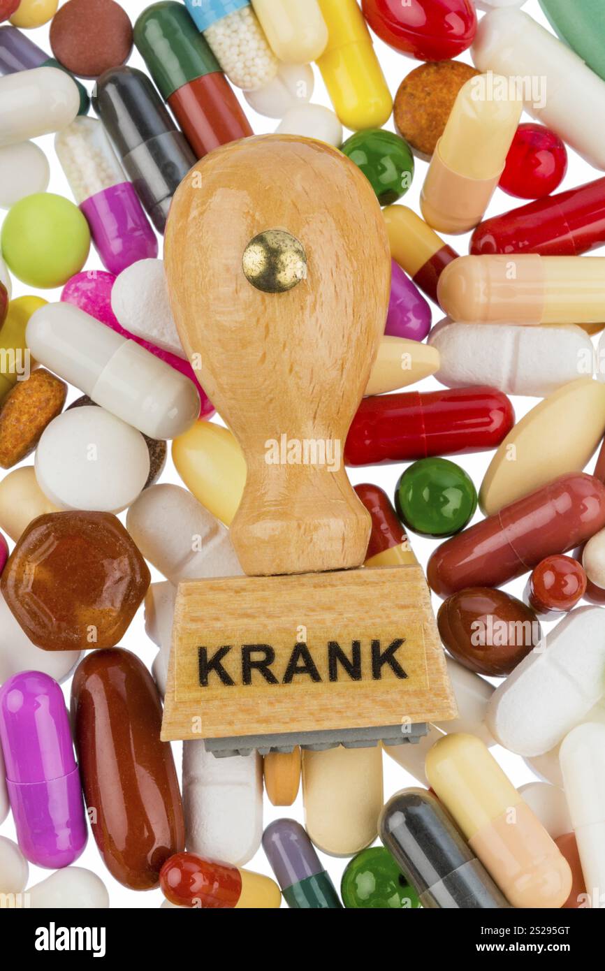 Stamp on colourful tablets, symbolic photo for illness, sick note and ...