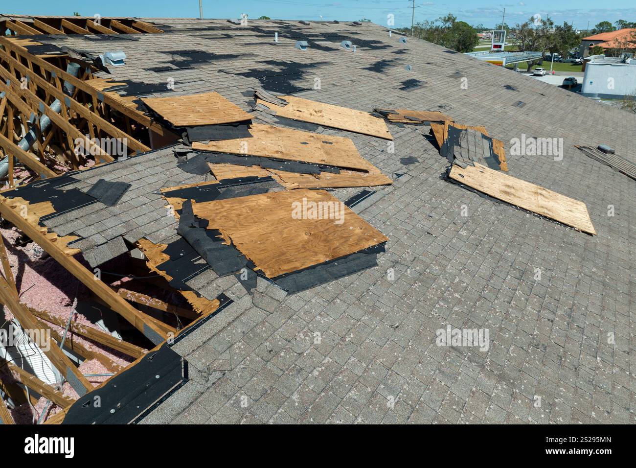 Damaged house roof with missing shingles after hurricane Ian in Florida ...