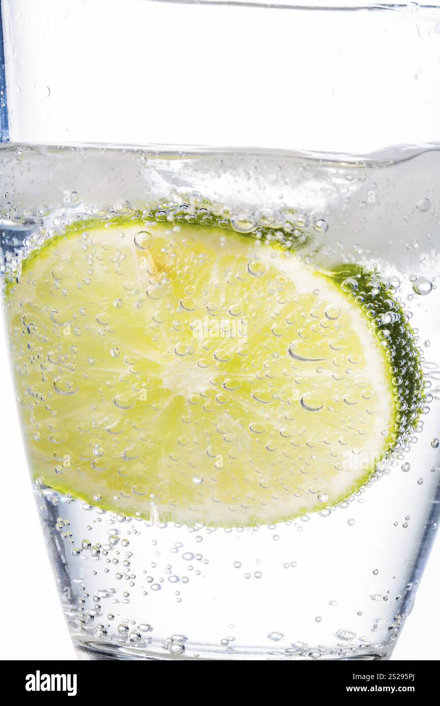 A glass of fresh drinking water and a lime. Mineral water to quench your thirst Stock Photo - Alamy