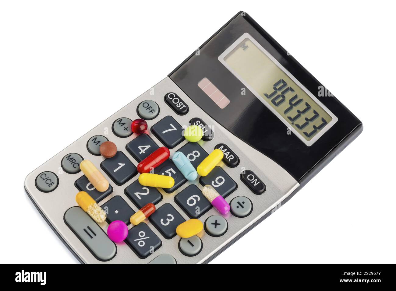 Tablets lying on a calculator. Symbol photo for costs in the medical ...