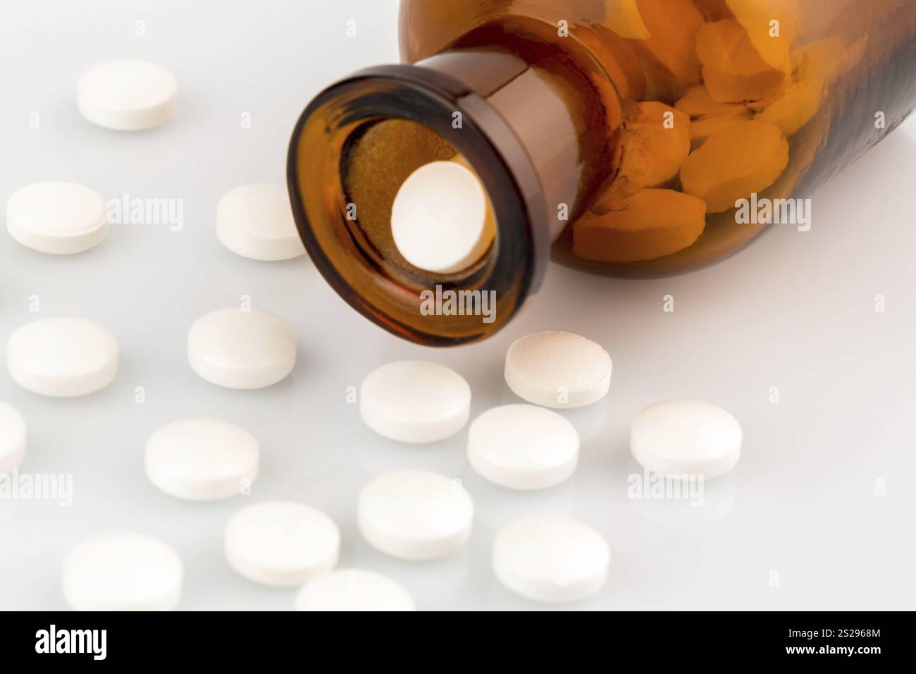 Many tablets with a glass container. Symbolic photo for addiction and ...