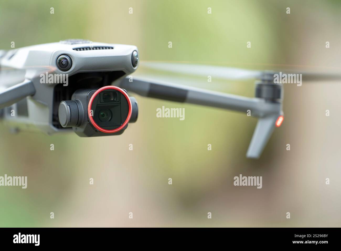 Drone aircraft with blurred fast rotating propellers and video camera ...