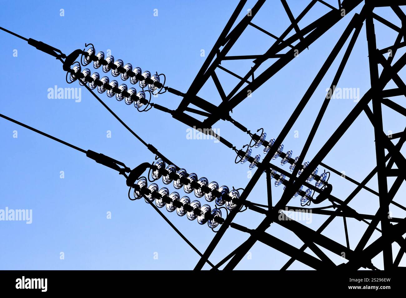 The pylon of a power line in front of a blue sky. High-voltage power ...
