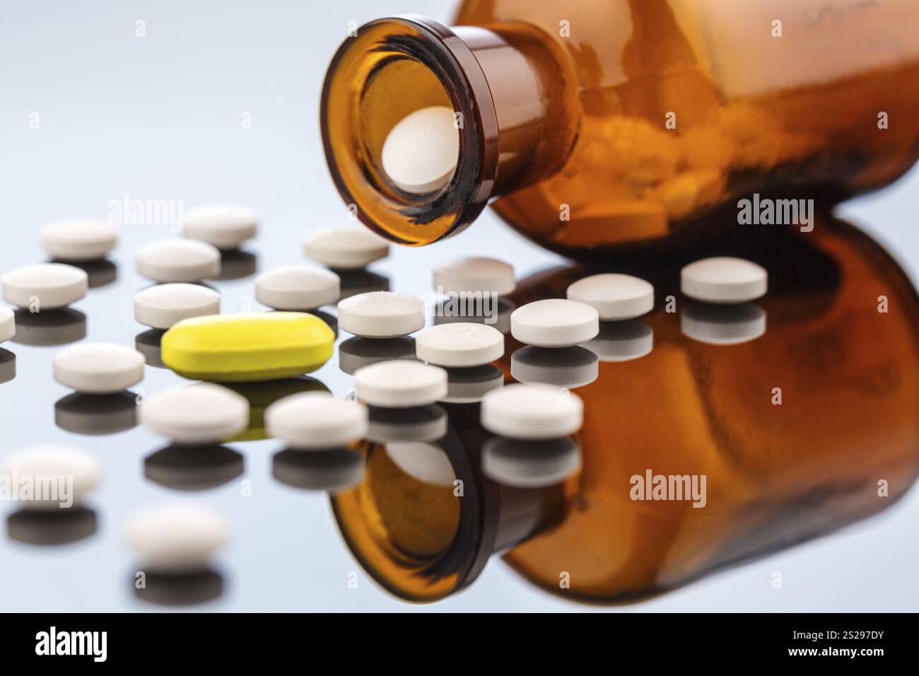 Many tablets with a glass container. Symbolic photo for addiction and ...