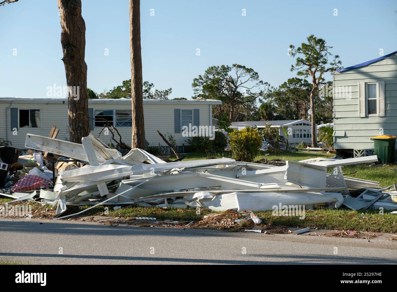 Heaps of debris rubbish on street side near severely damaged by ...