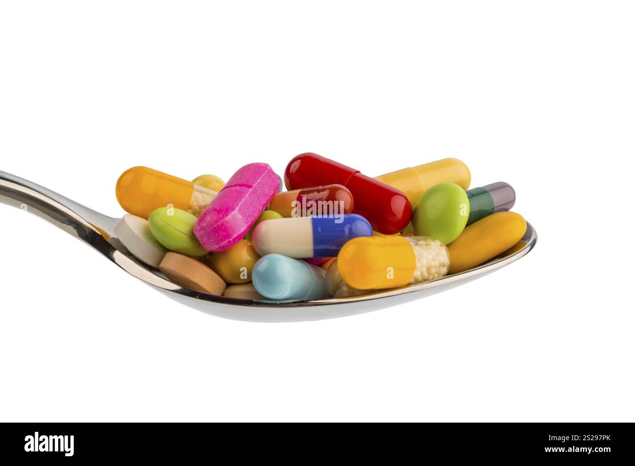 Many colourful tablets on a spoon. Symbolic photo for tablet addiction ...