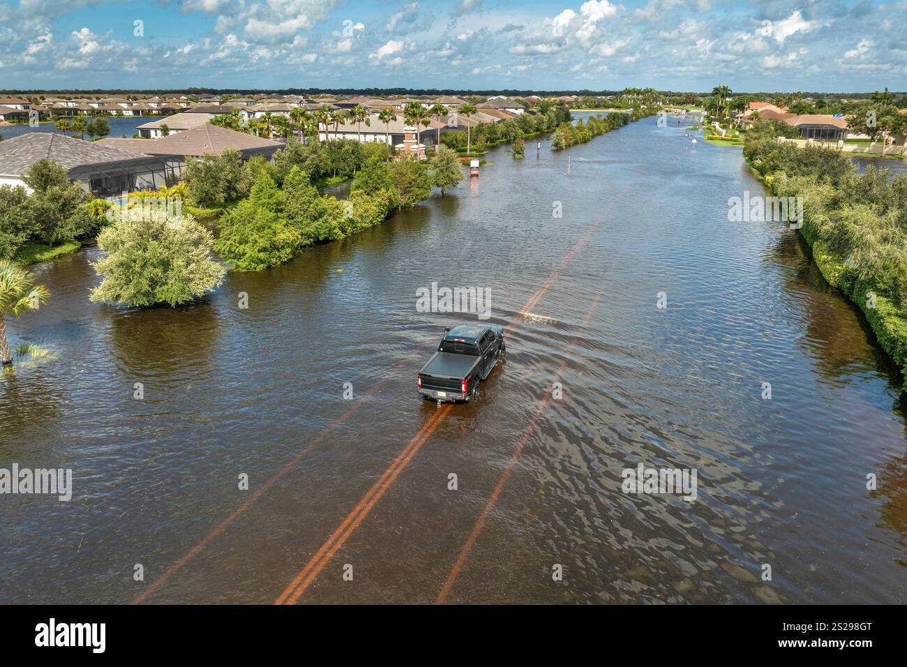 Hurricane rainfall flooded road. Drowned car on city street in Florida ...