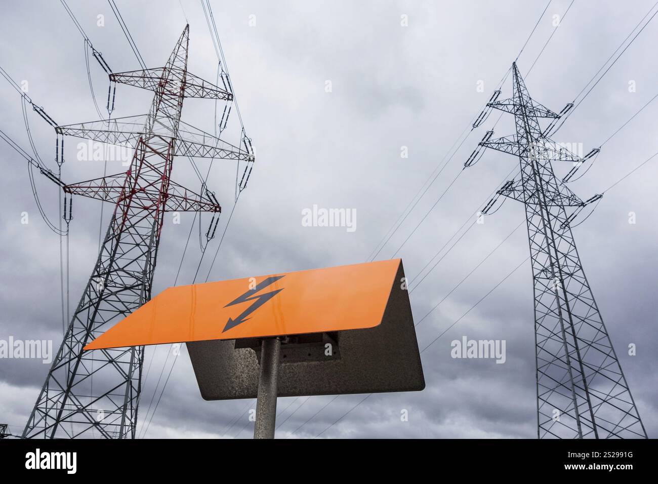 The pylon of a high-voltage power line in front of dark clouds. Austria ...