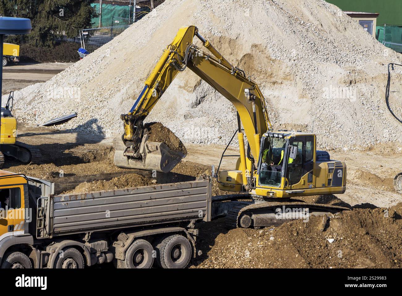 Excavator on a building site. Excavator shovel with earth, earthworks ...