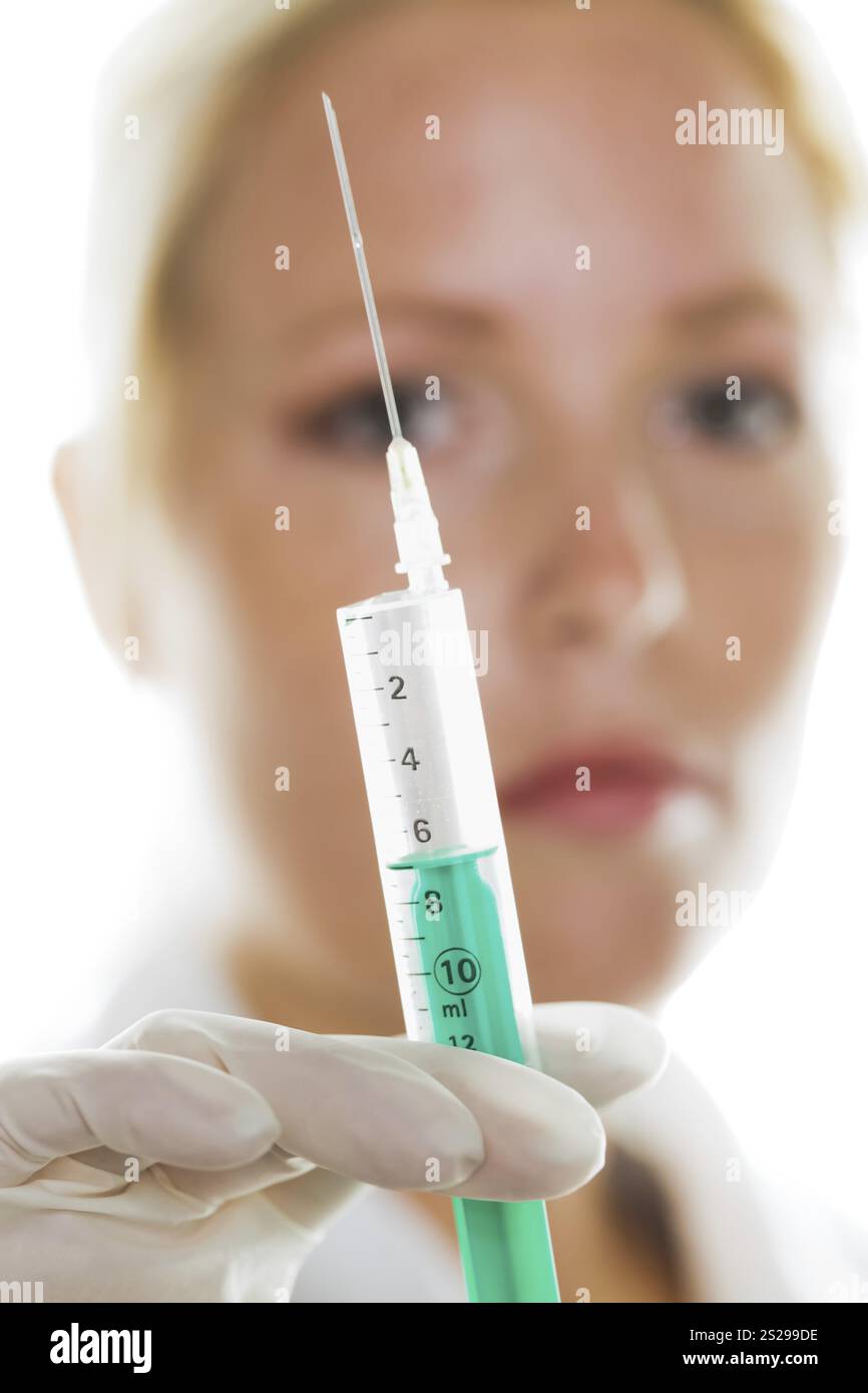 A young doctor with a syringe. Symbolic photo for injections, medicine ...