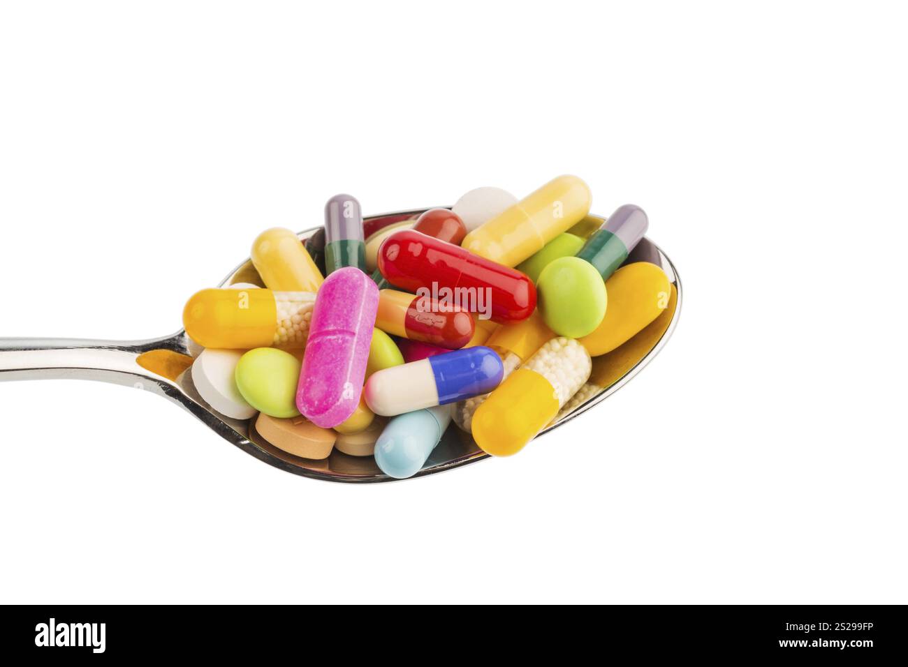 Many colourful tablets on a spoon. Symbolic photo for tablet addiction ...