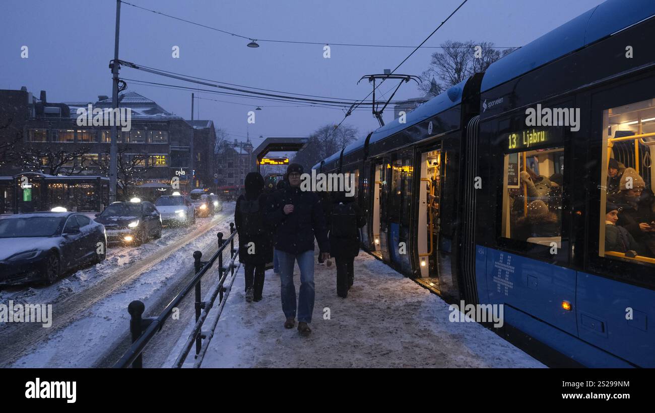 Oslo, Norway. 6th Jan, 2025. Passengers get on and off a tram in snow in Oslo, capital of Norway ...