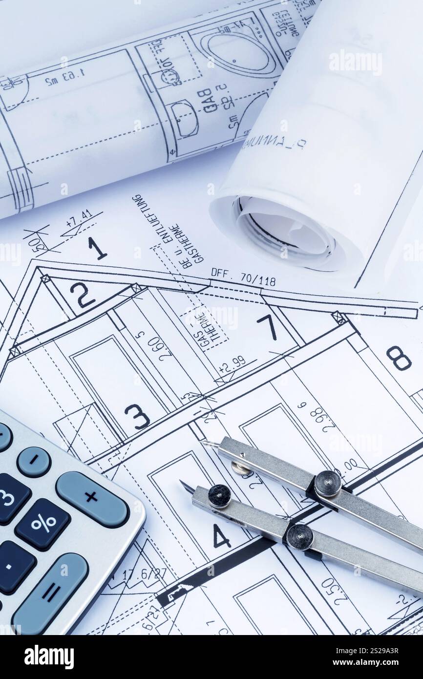 An architect's construction plan with a calculator. Symbolic photo for ...