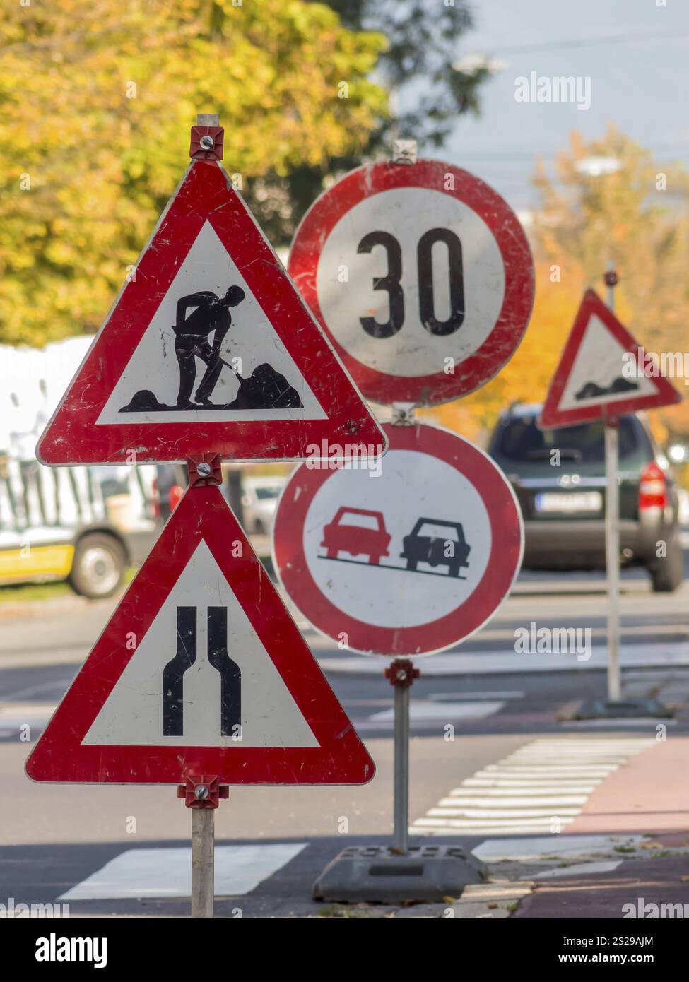 A road construction site is secured by several traffic signs. Austria ...