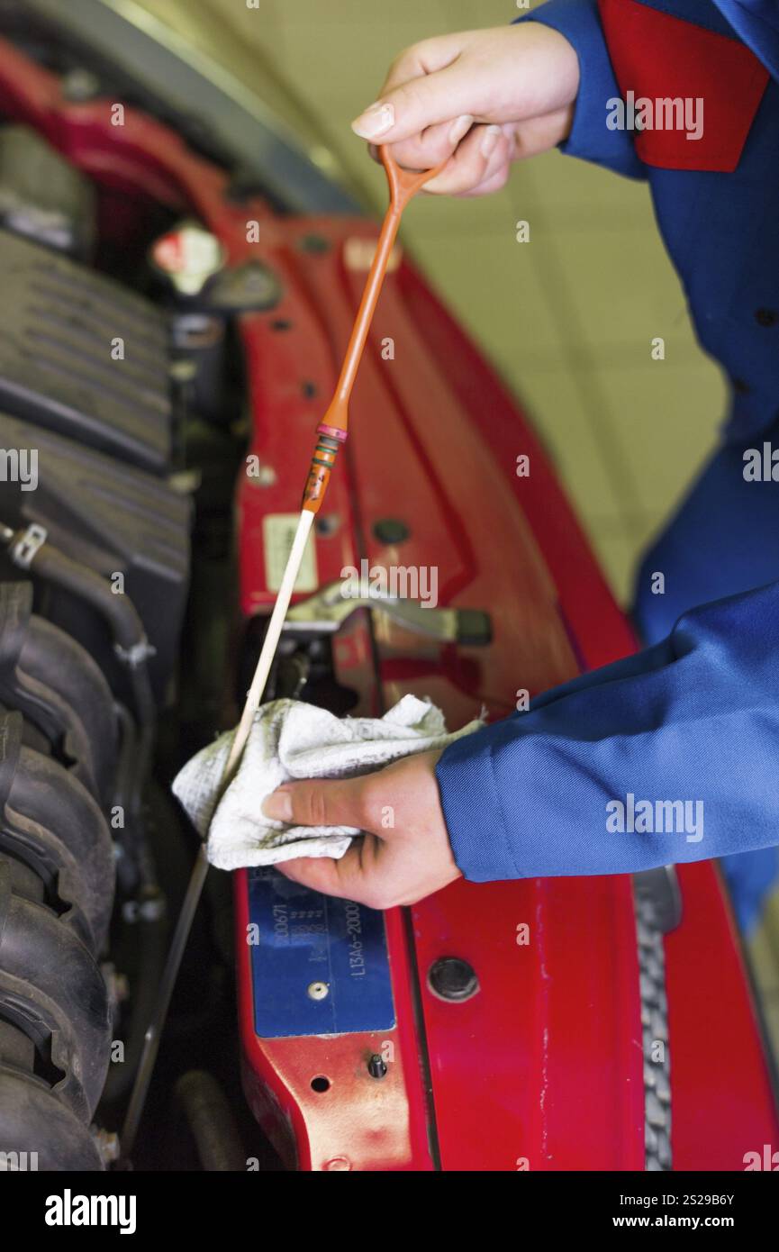 Oil pressure in the car is measured. The oil dipstick is used to check ...