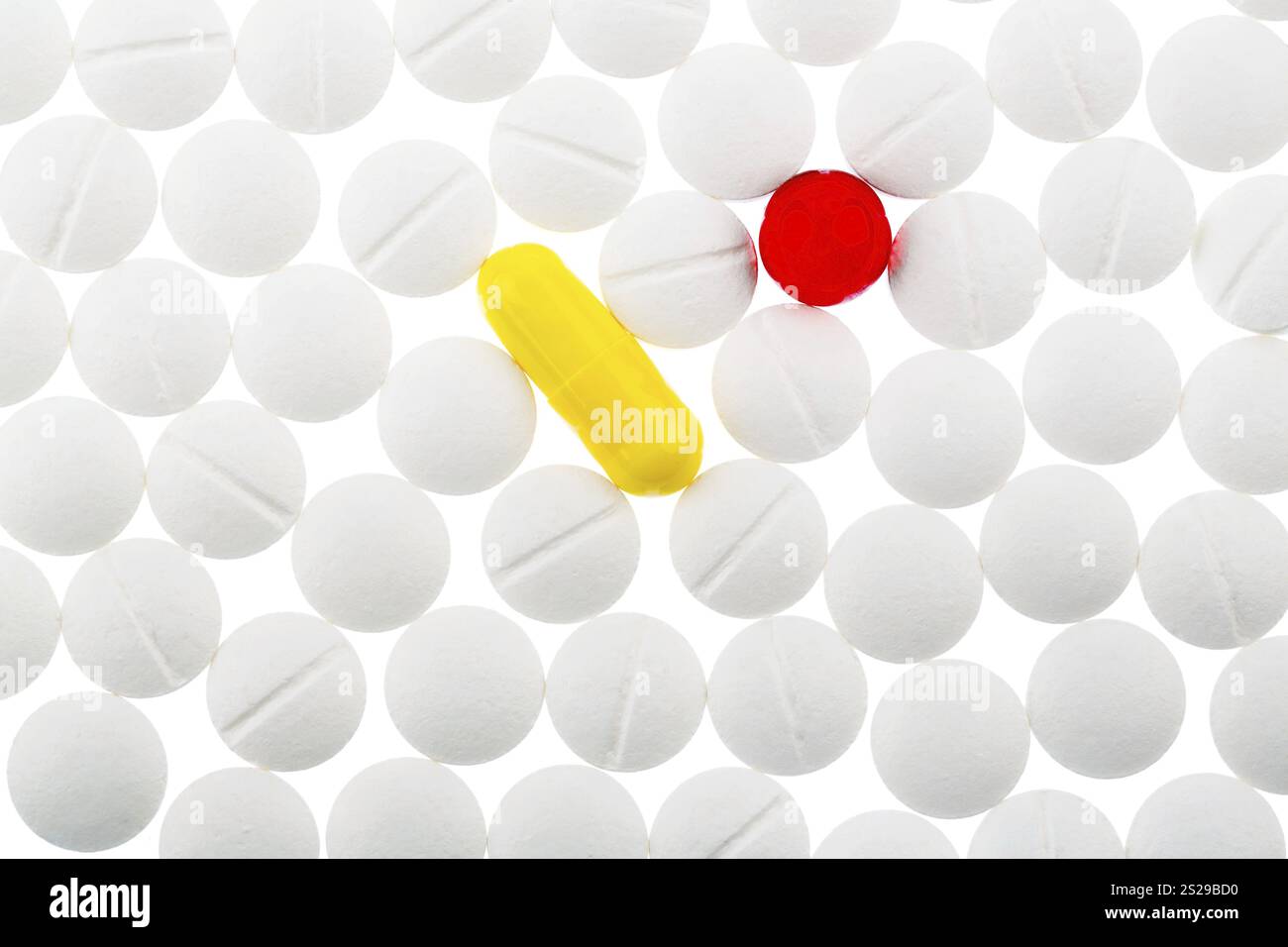 White and coloured tablets, symbolic photo for medicine, remedies and ...
